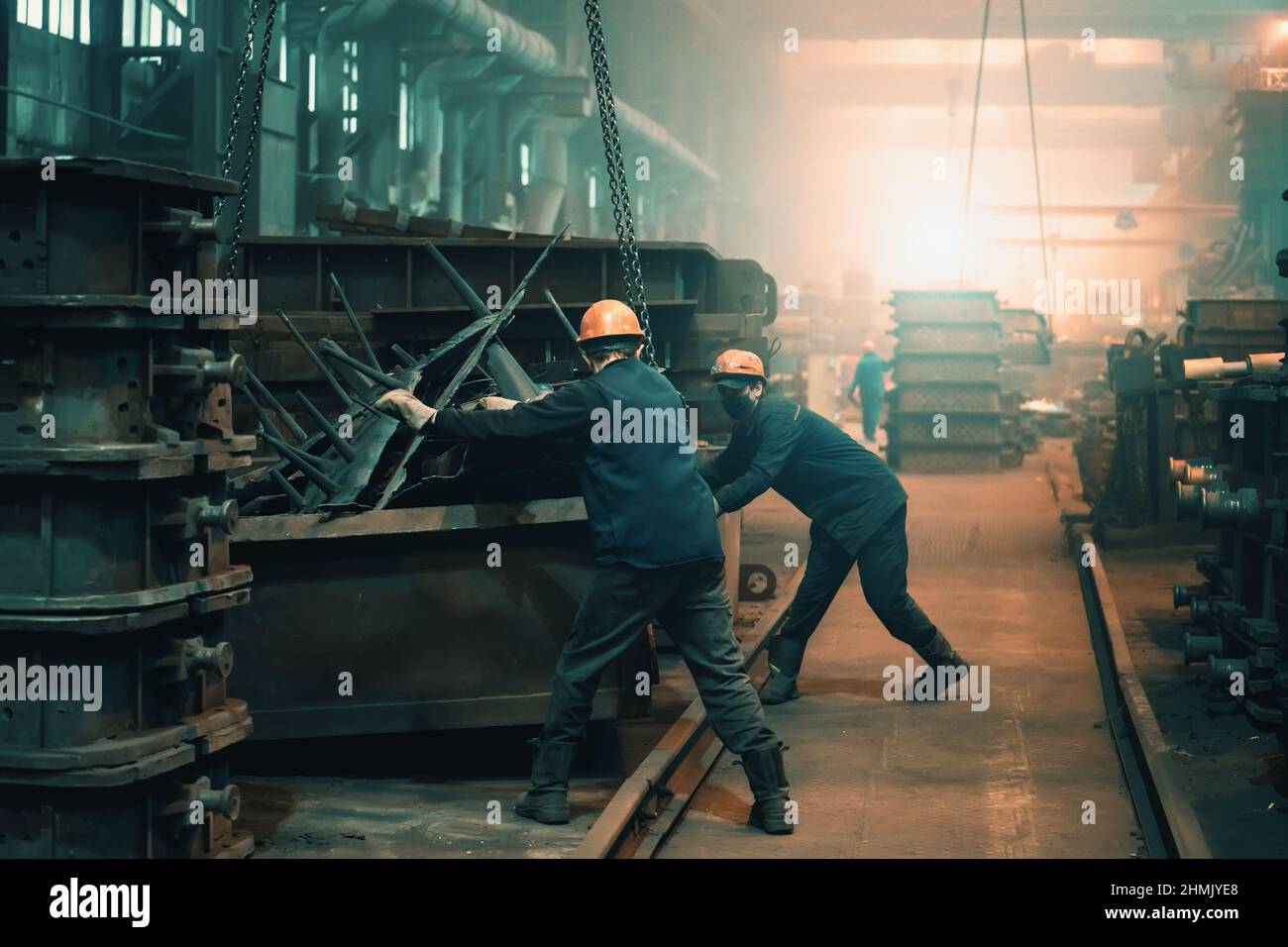 Workers at metallurgical plant. Working with scrap metal. Metal ...