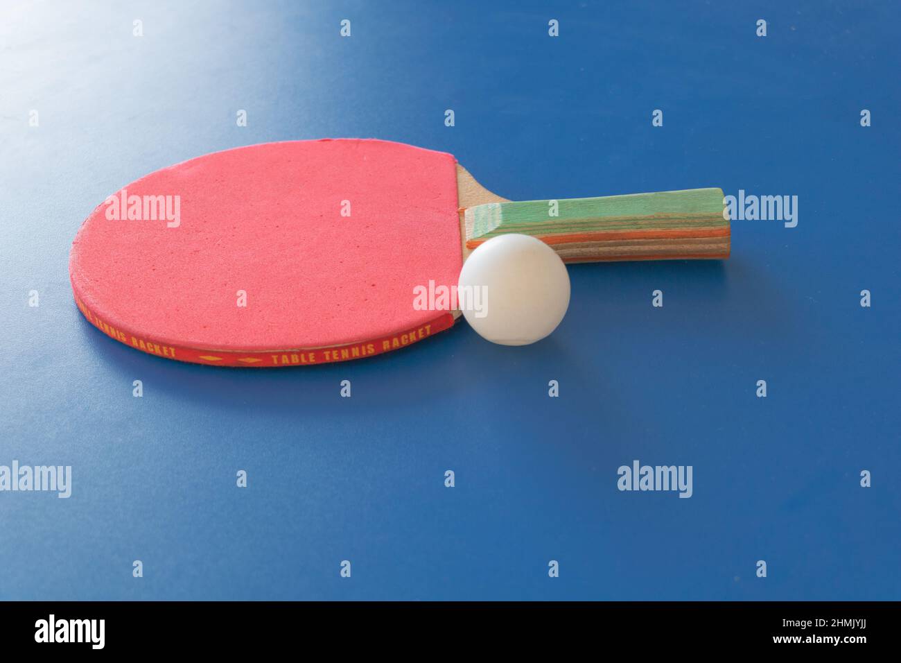 loseup of a red ping pong table and a white table on a blue table Stock ...
