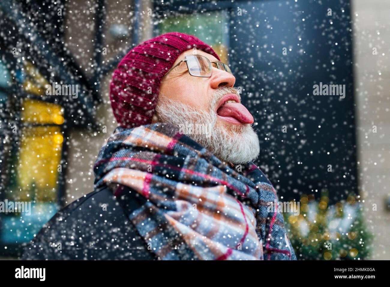 happy good looking mature man sticking out his tongue catches ...