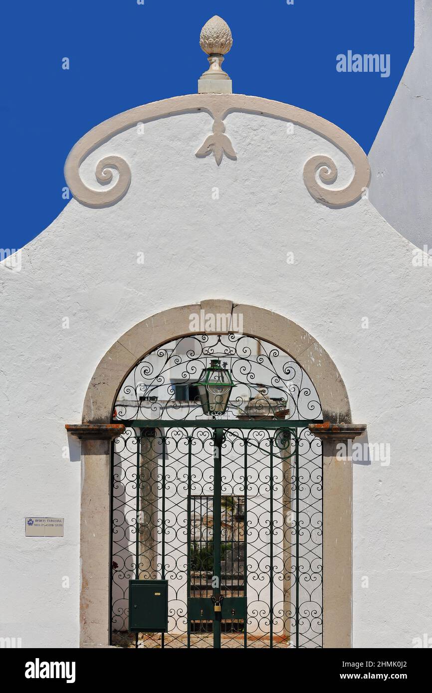 Closed side door-lattice grate-round arch-Our Lady of Carmel Church ...