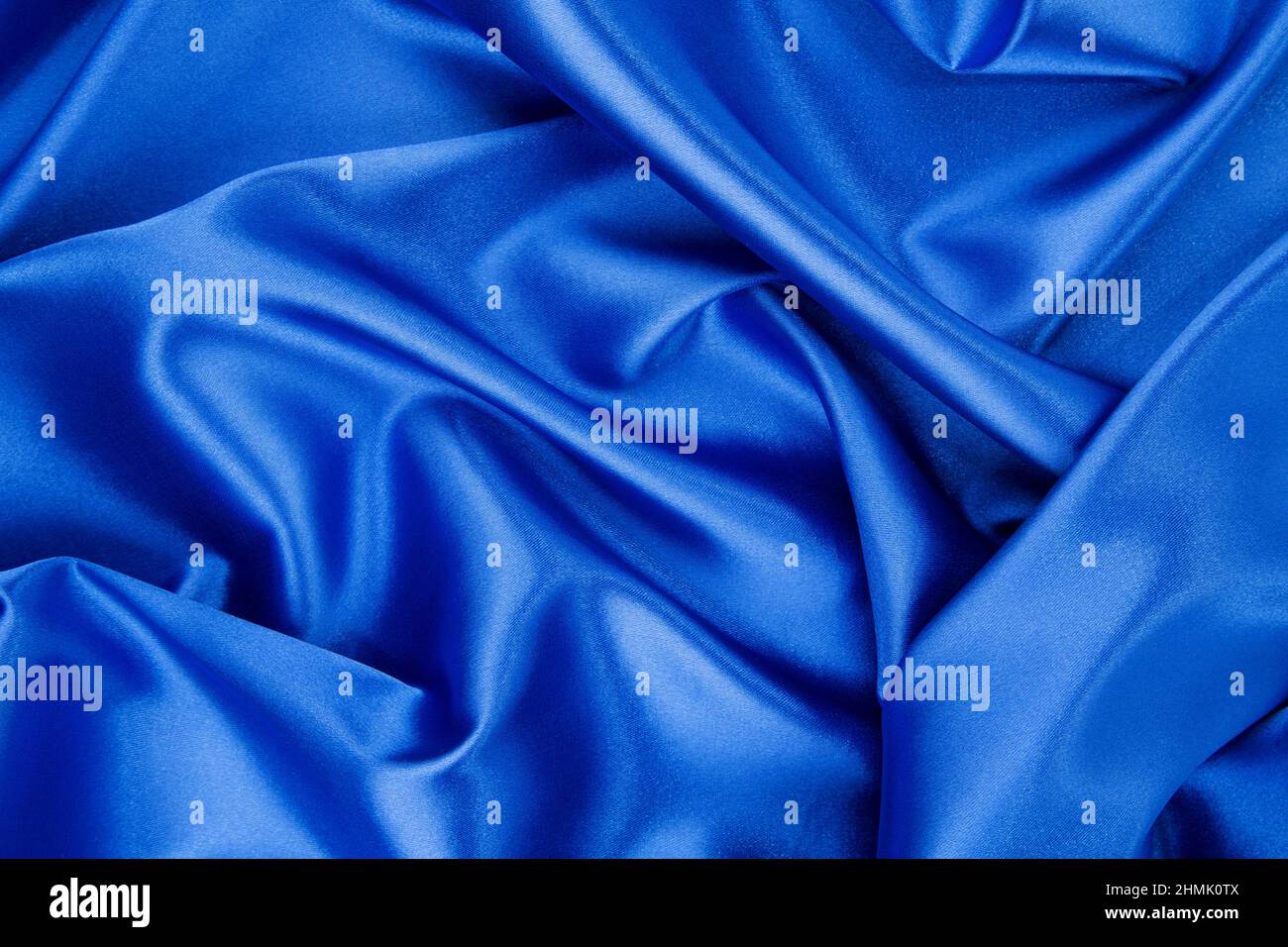 Blue silk folds texture close up. Whole background Stock Photo - Alamy