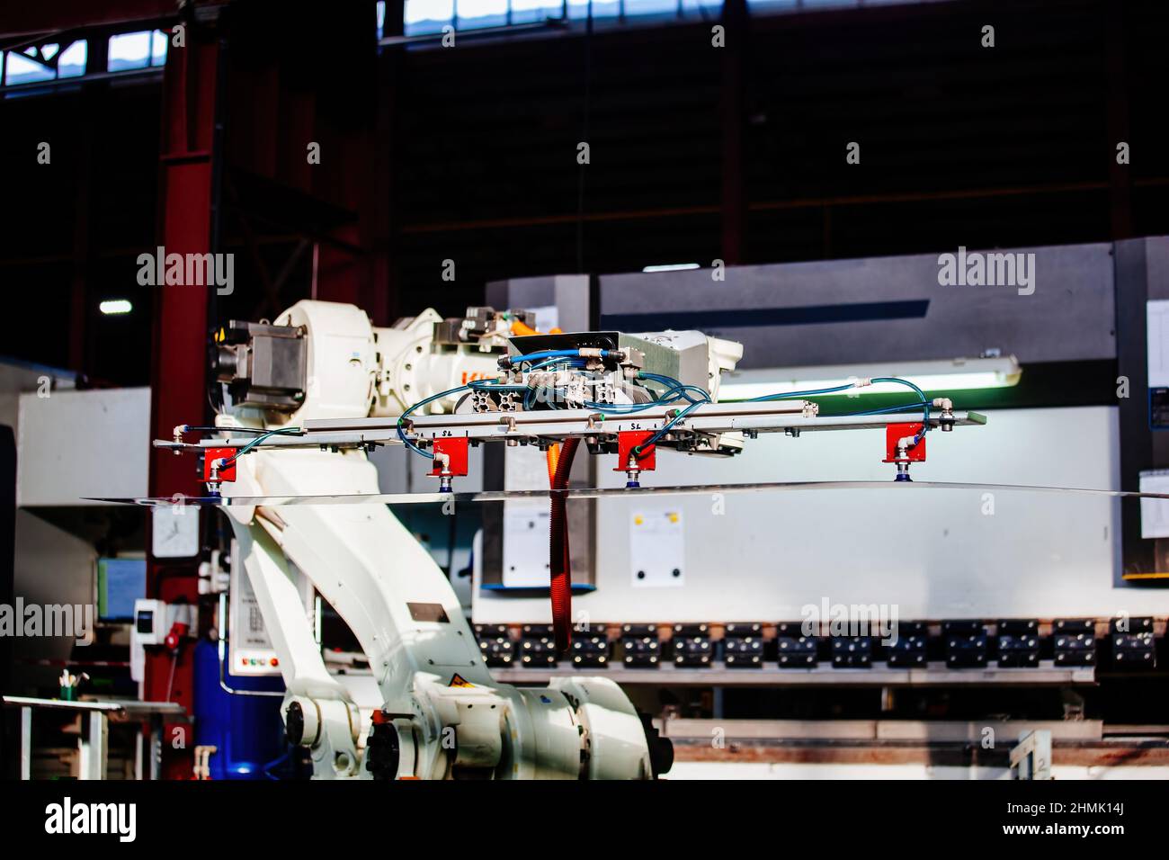 Robotic arm working with metal sheet at hydraulic bending machine Stock ...