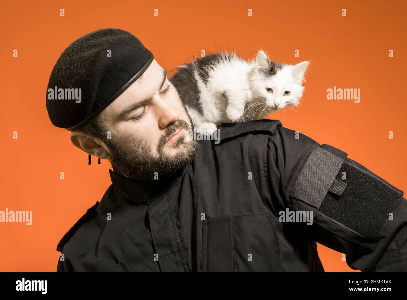 Military. The bodyguard interacts with the cat. A male security guard ...