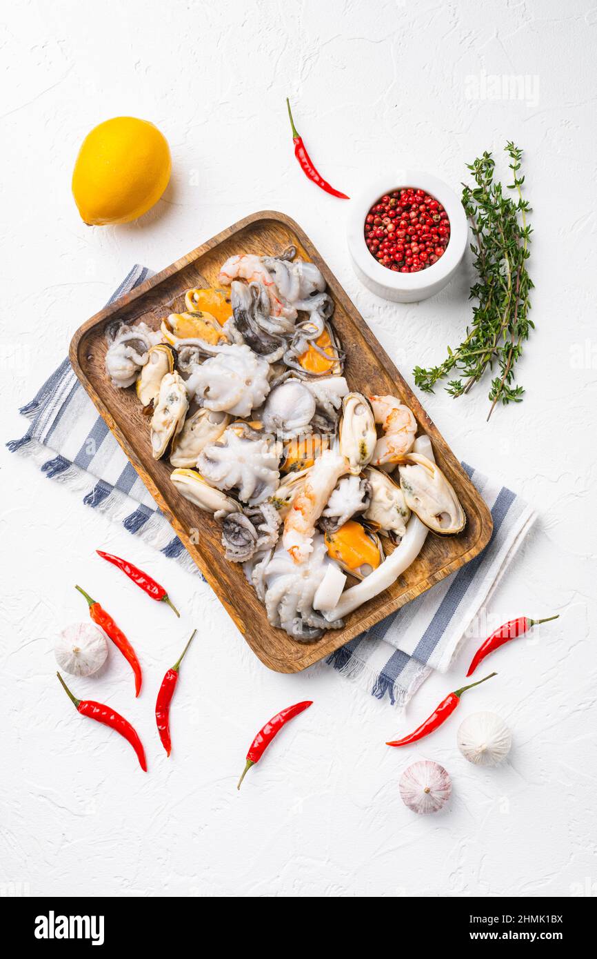 Raw seafood mussels, squid octopus set, on white stone table background ...