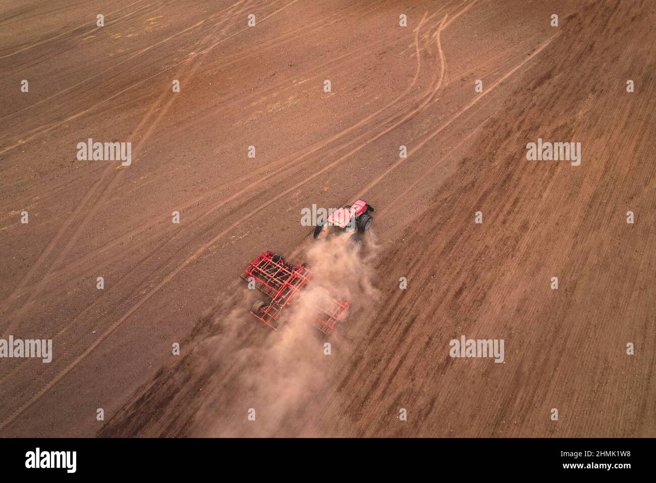 Field cultivating, aerial view. Tractor with disk harrow on plowed ...