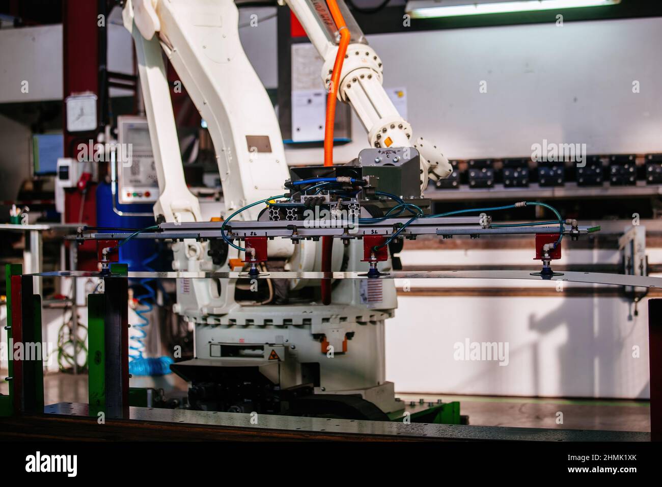 Robotic arm working with metal sheet at hydraulic bending machine Stock ...