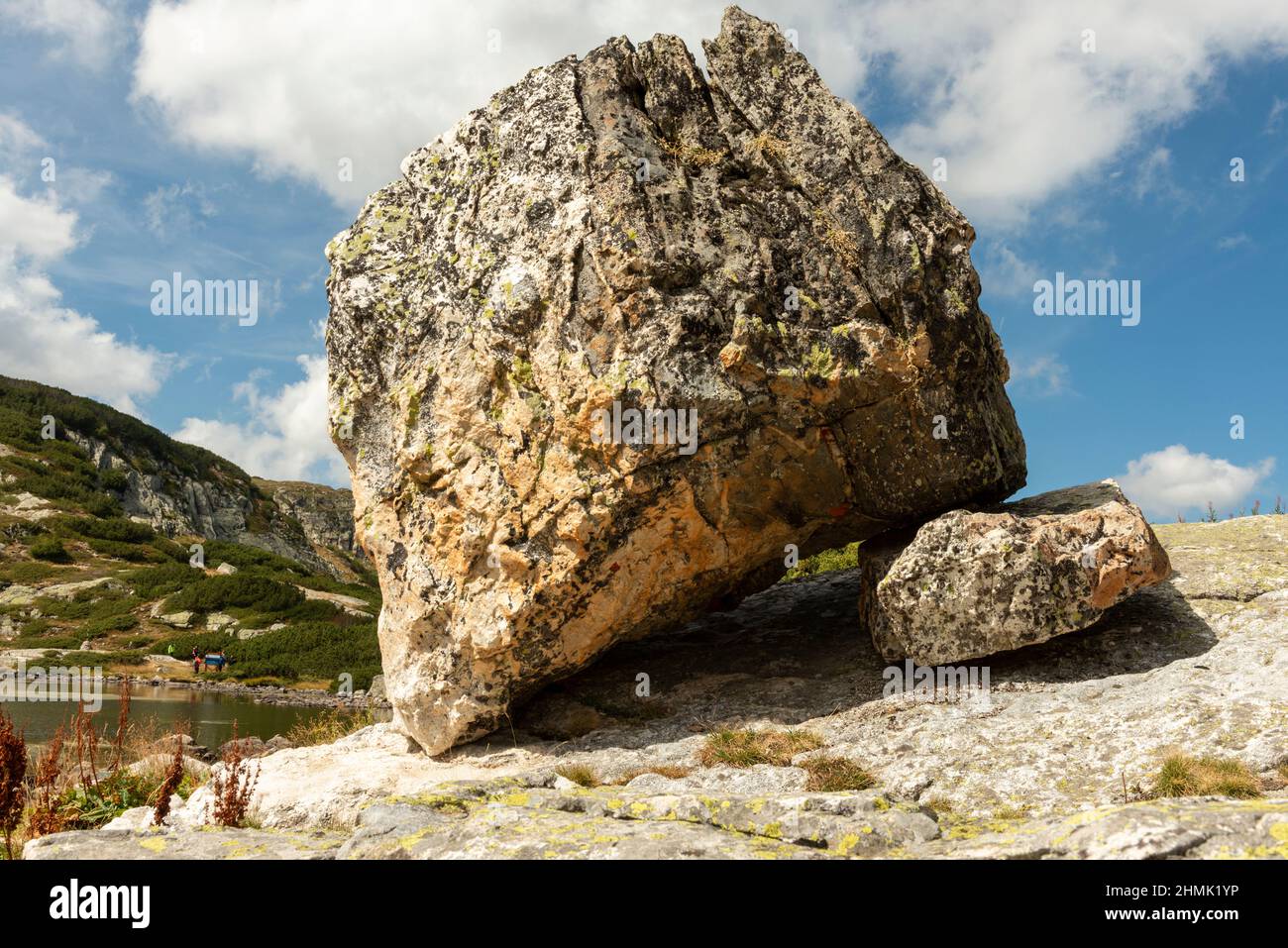 Large glacial erratic boulder balancing on roche moutonnée surface or ...