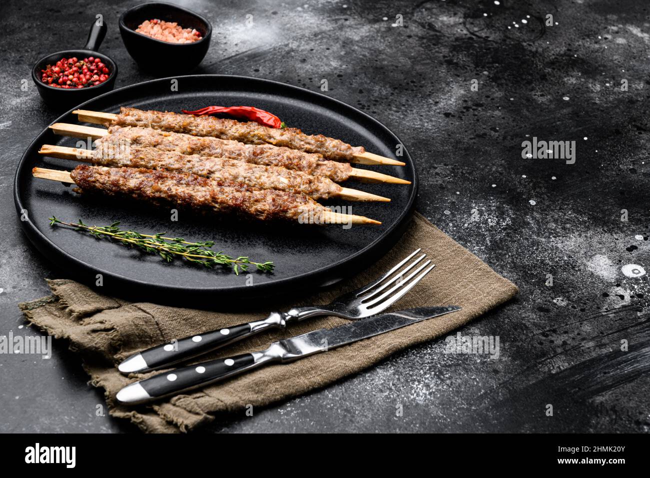 Turkish meat kebab set, on plate, on black dark stone table background ...