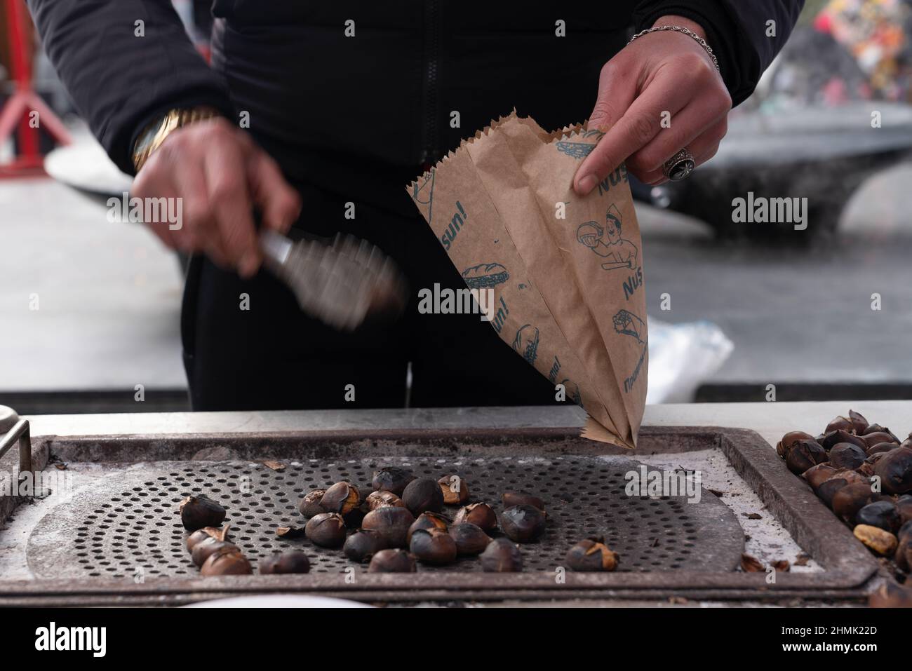 Baku, Azerbaijan - January 03 2022- Roasted chestnut seller stuffing ...