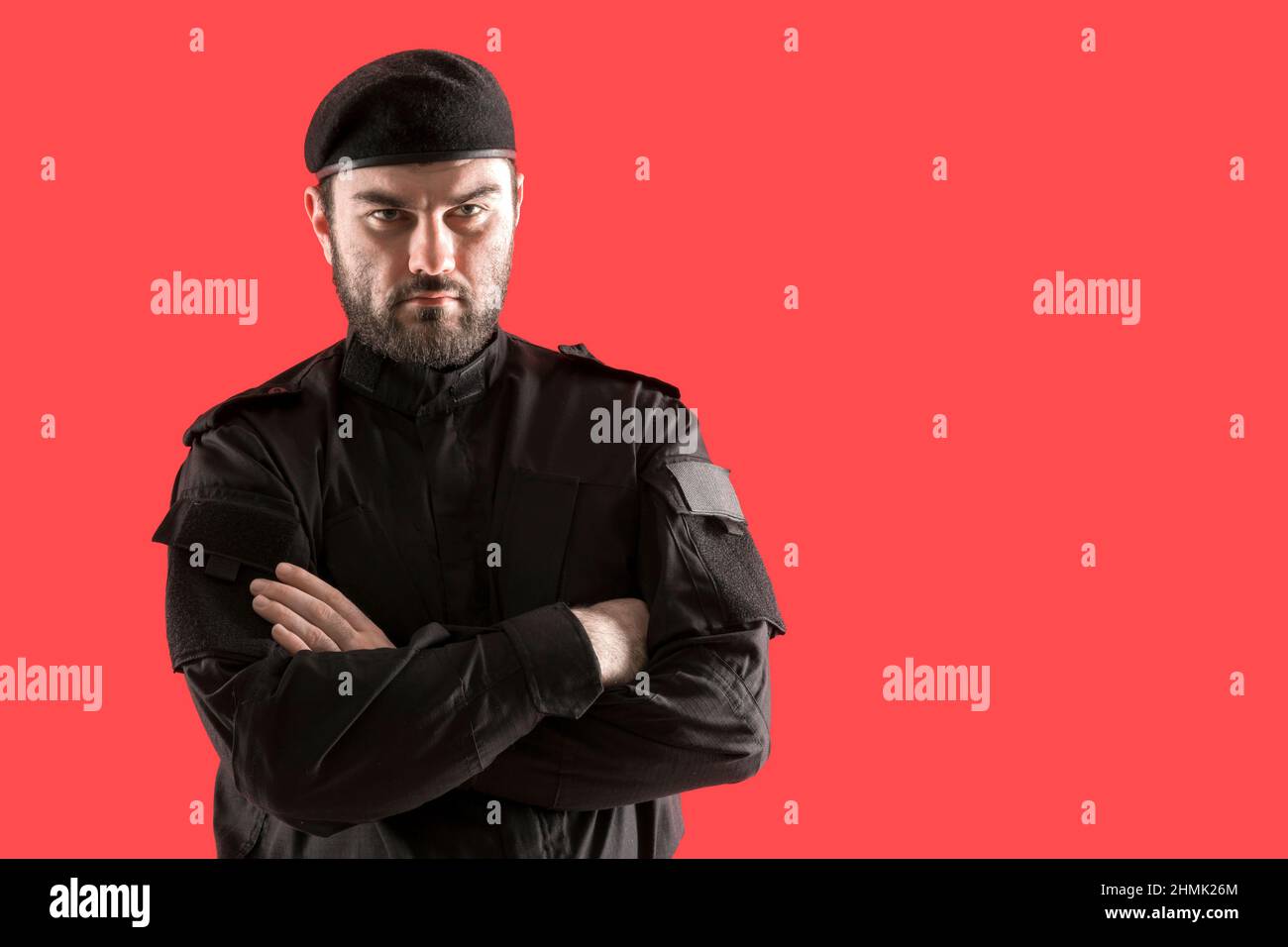 Bodyguard. Military. A male security guard in a black uniform and a cap ...