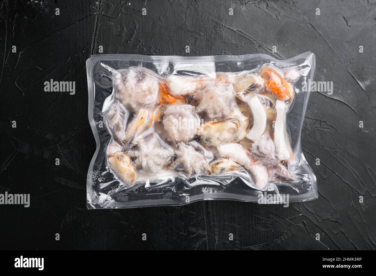 Frozen seafood pack set, on black dark stone table background, top view ...