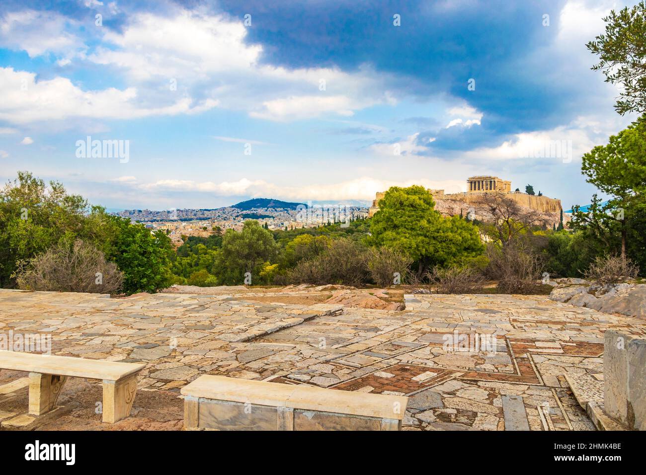 Acropolis of Athens on hill with amazing and beautiful ruins Parthenon and blue cloudy sky in ...