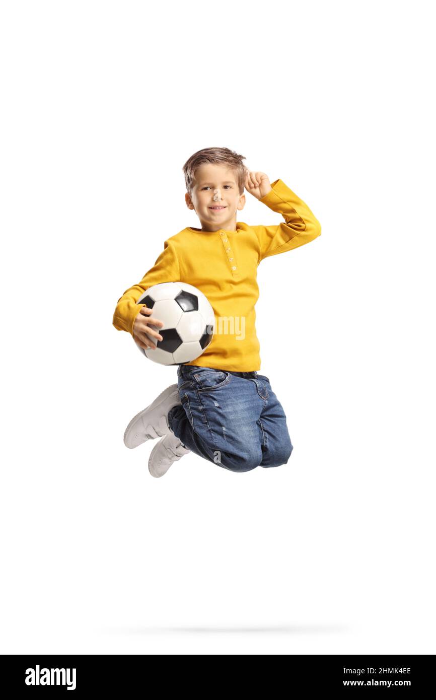 Full length shot of a boy holding a football and jumping isolated on ...