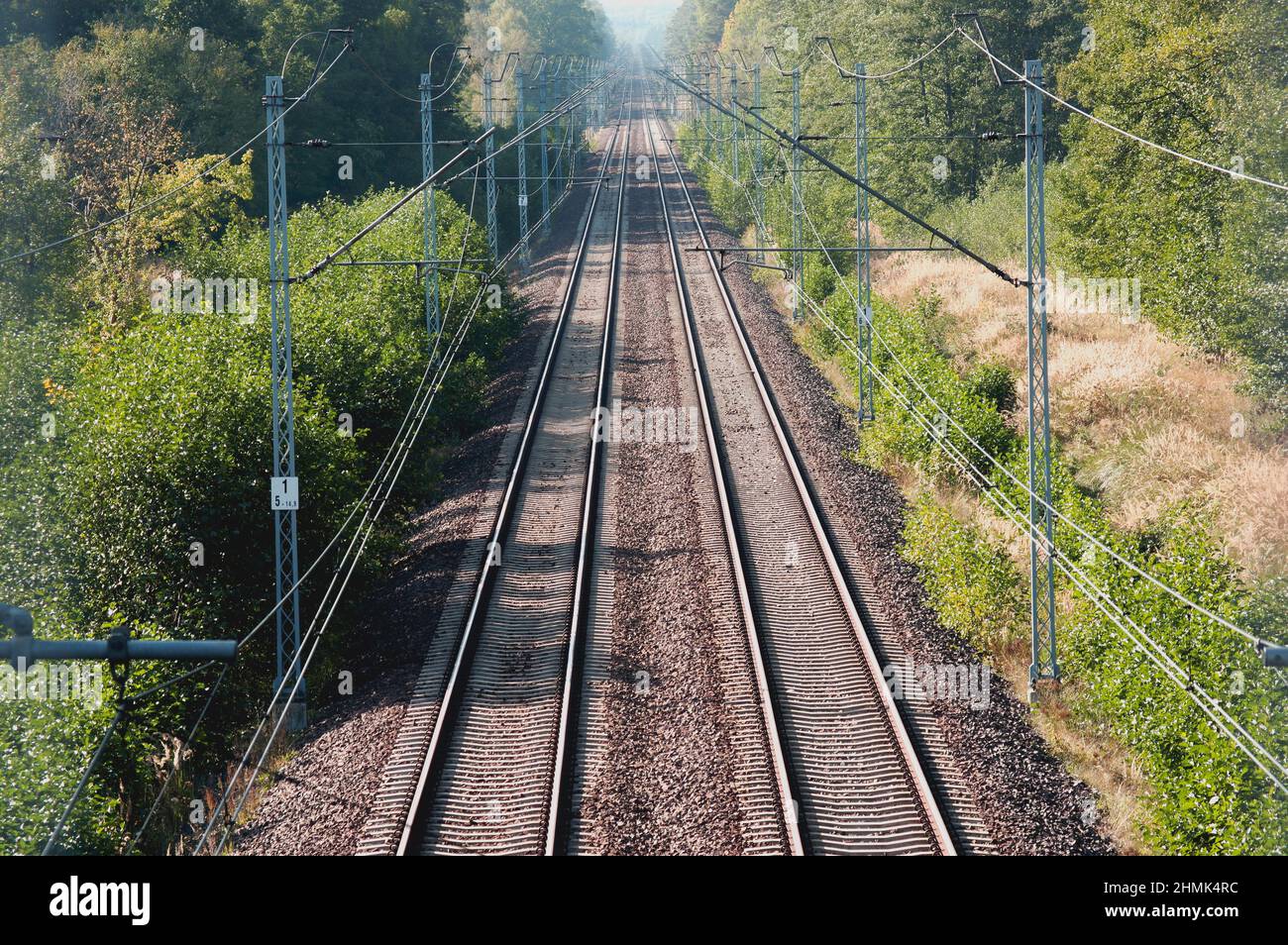 Two parallel electric traction tracks viewed from above. On both sides ...