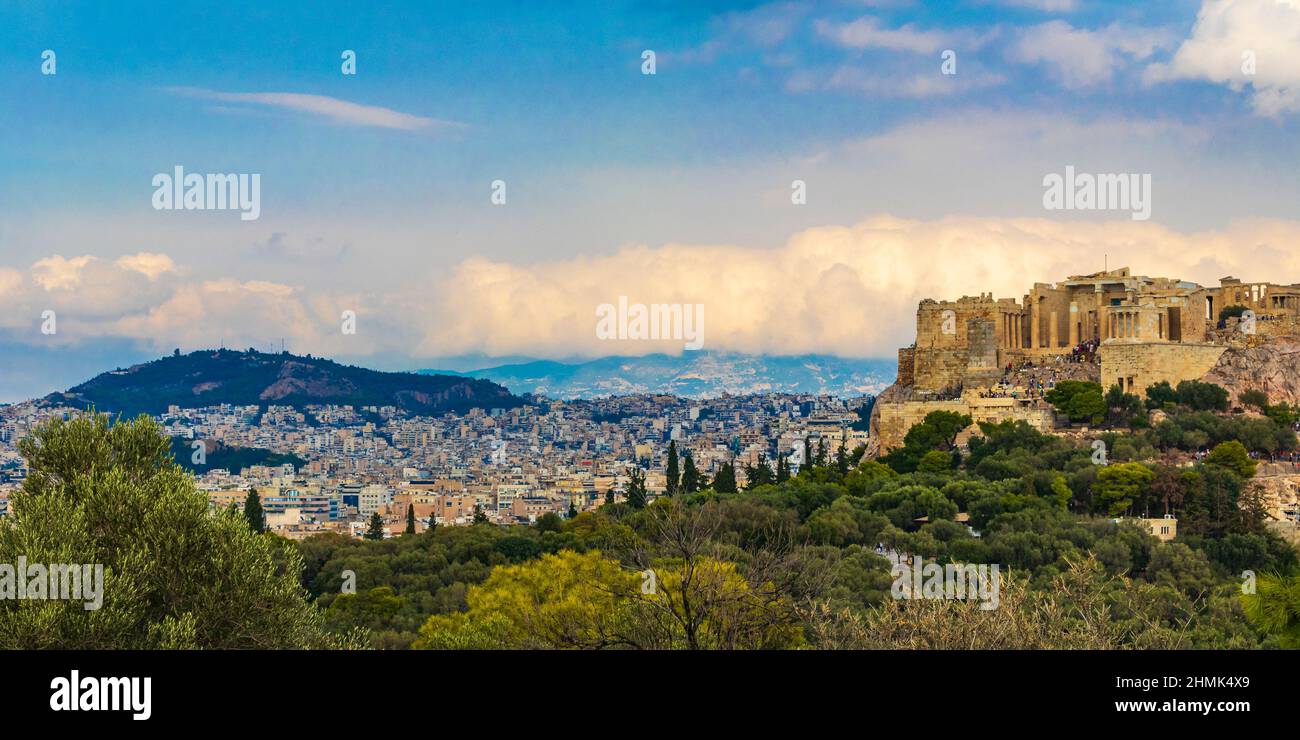 Acropolis of Athens on hill with amazing and beautiful ruins Parthenon and blue cloudy sky in ...