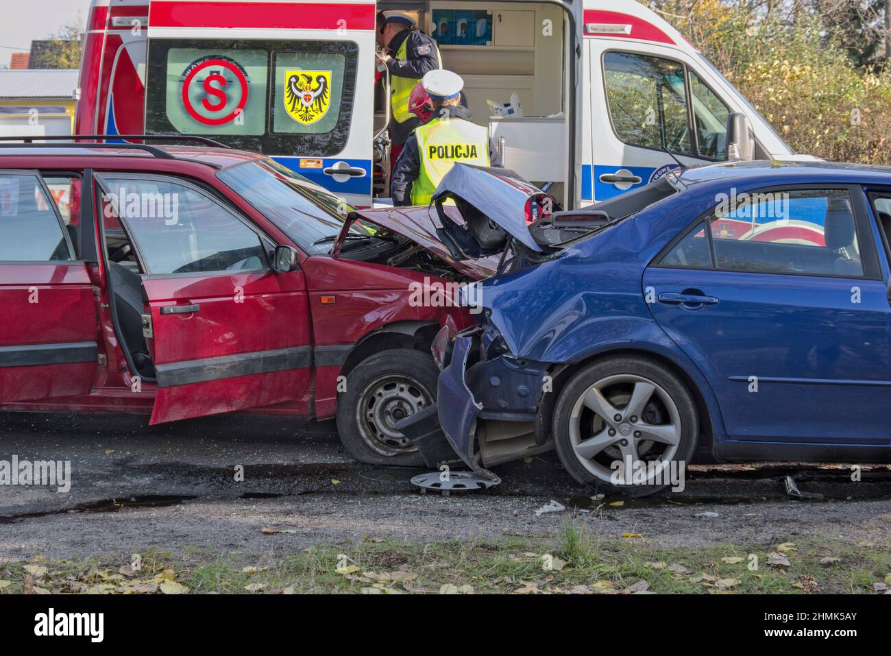 Rear impact site of two passenger cars and a truck. Rescue services are ...