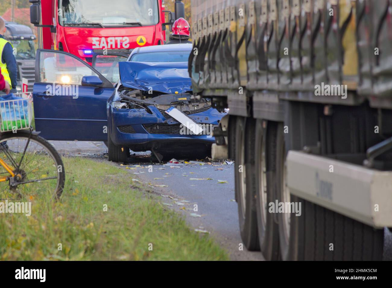 Rear impact site of two passenger cars and a truck. Rescue services are ...