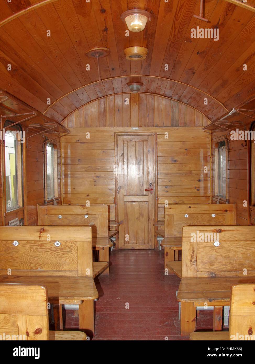 The interior of a historic passenger rail car. The interior has wooden ...