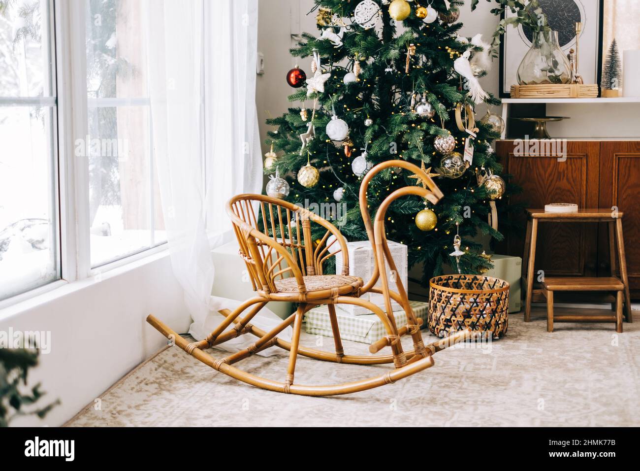 Baby rocking chair near the Christmas tree Stock Photo - Alamy