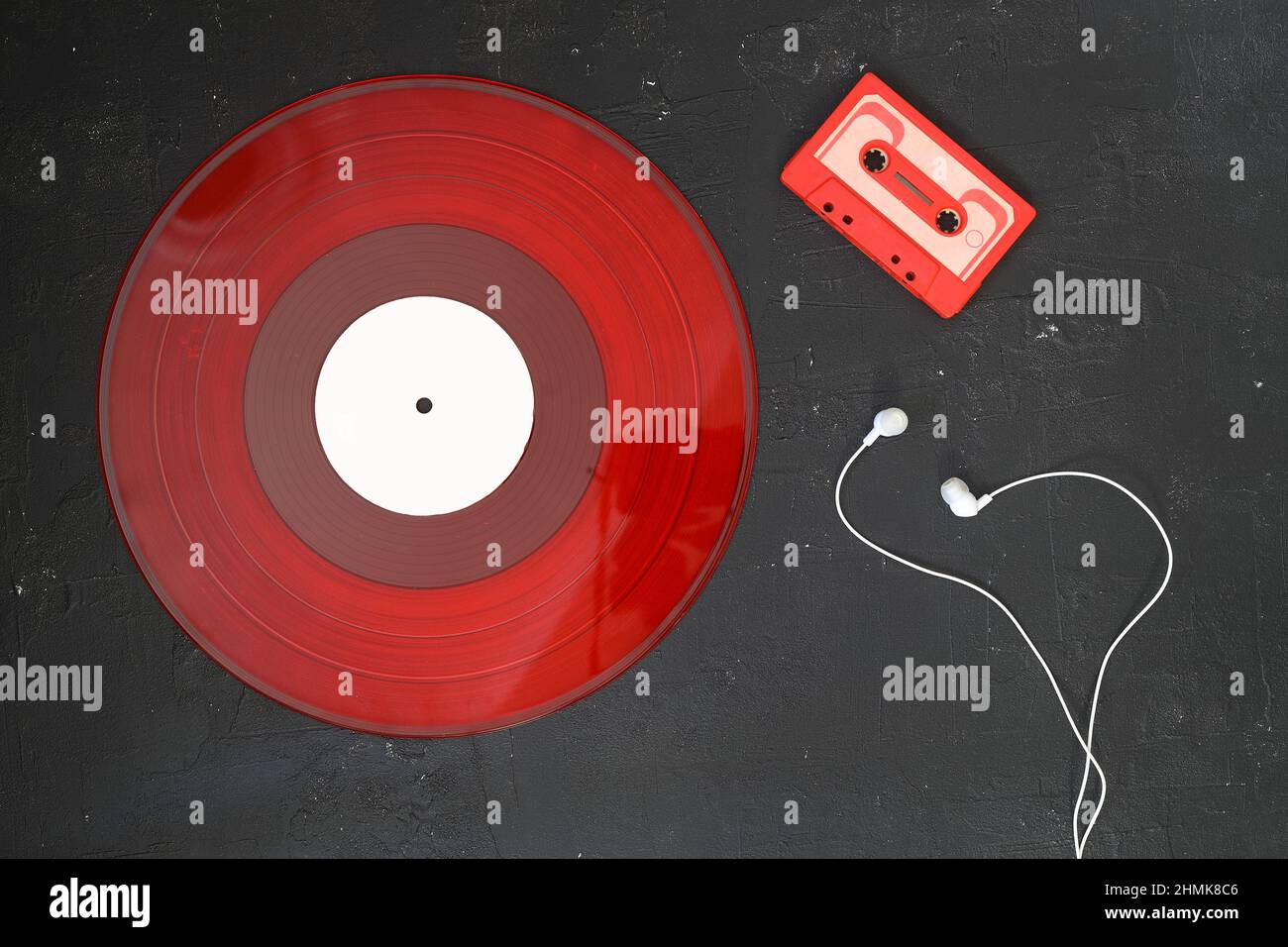 Red Audio cassette and Red vinyl record on a black background. Retro ...