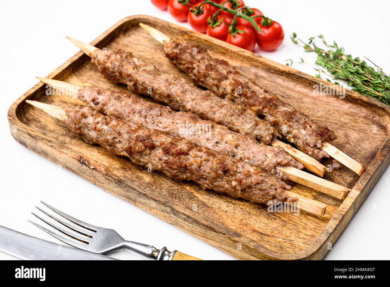 Lula kebab on skewers set, on white stone table background Stock Photo ...