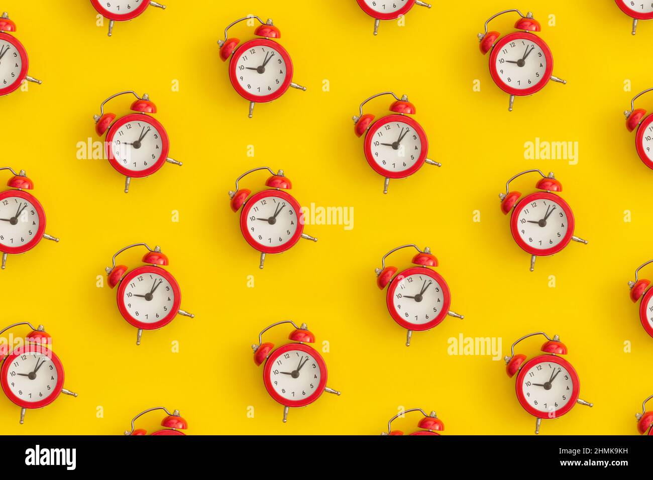 Pattern composition of black antique alarm clock on yellow background ...