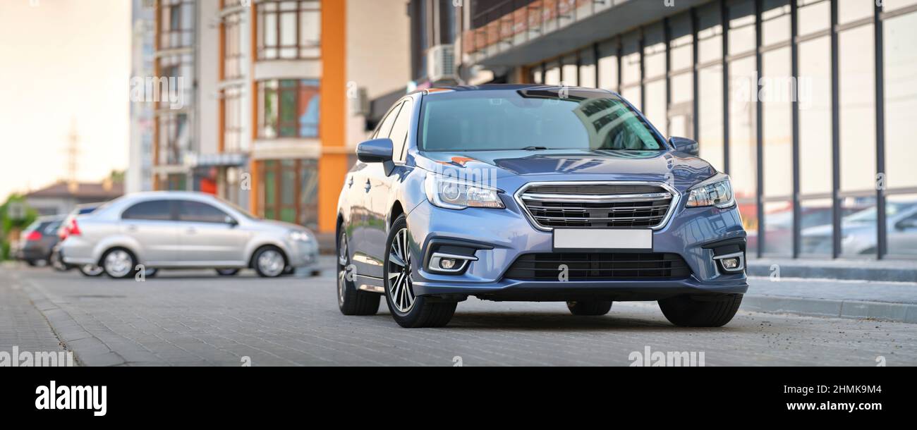 Front view of new car parked on city street side Stock Photo - Alamy