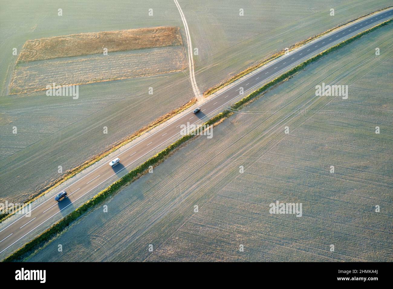 Aerial view of intercity road with fast driving cars at sunset. Top ...