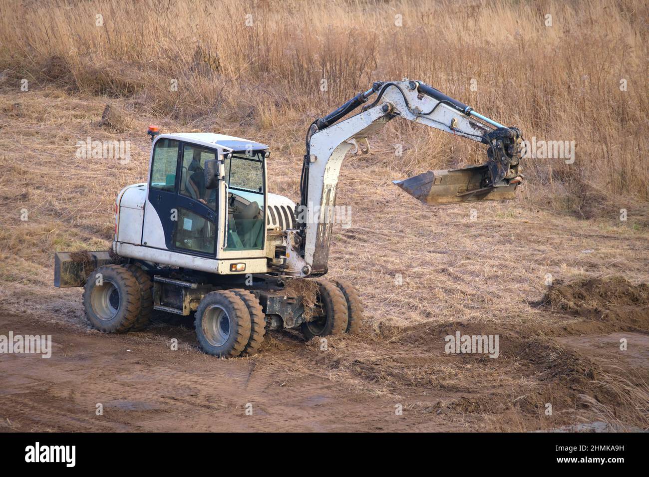 Earth moving tractor preparing place for future house foundation ...