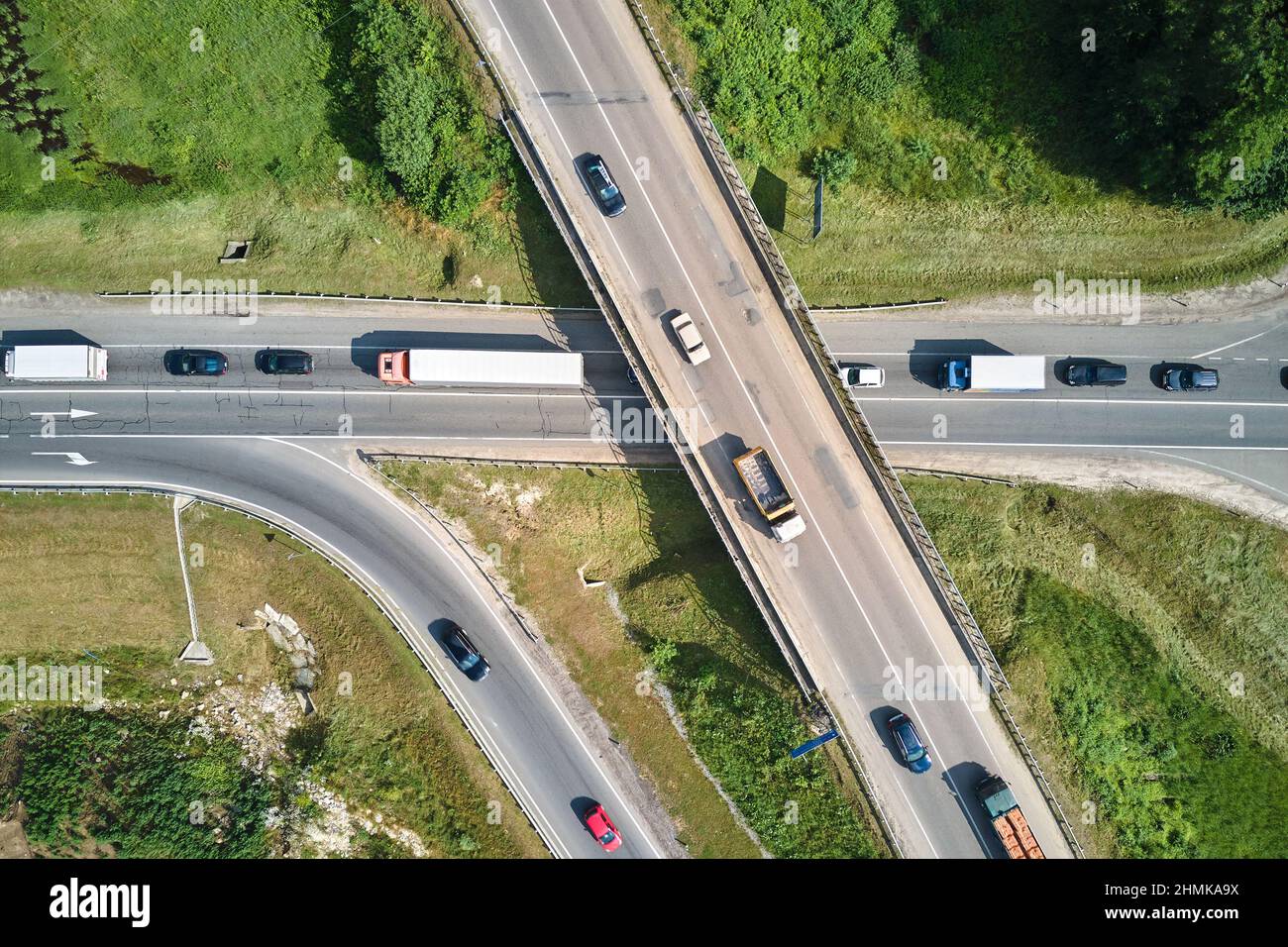 Aerial view of road intersection with fast moving heavy traffic on city ...