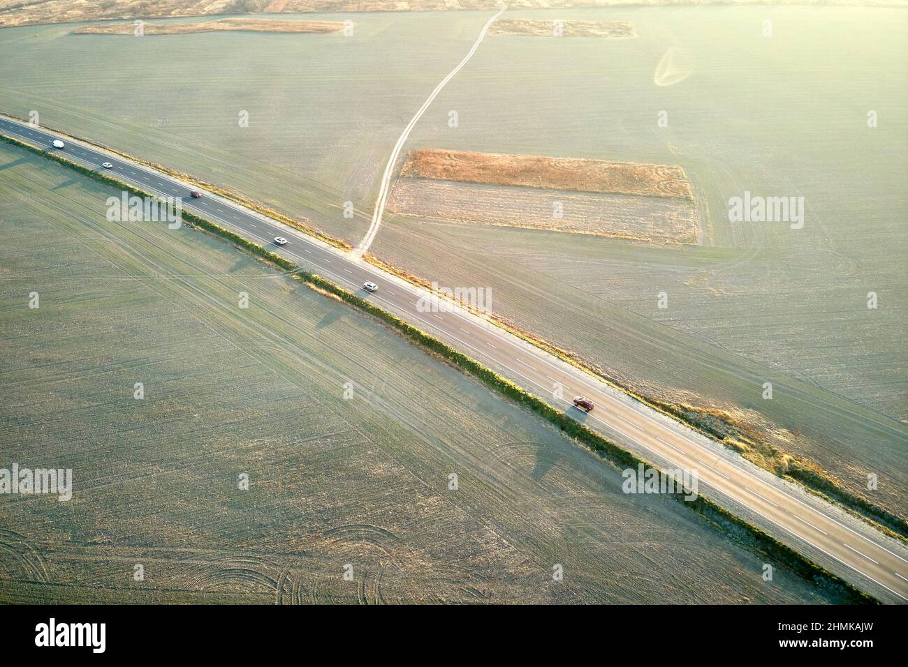 Aerial view of intercity road with fast driving cars at sunset. Top ...