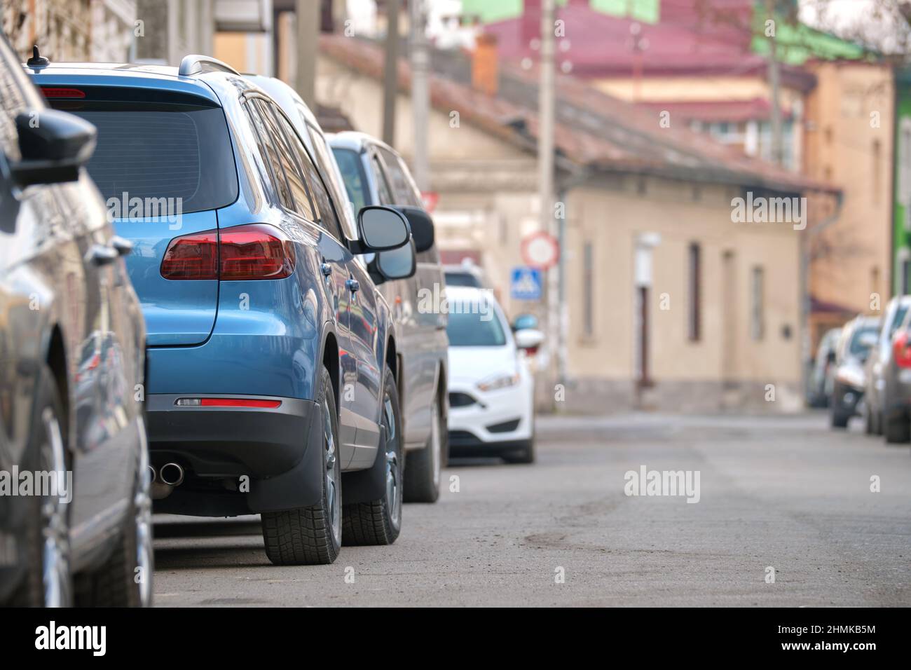 City traffic with cars parked in line on street side Stock Photo - Alamy