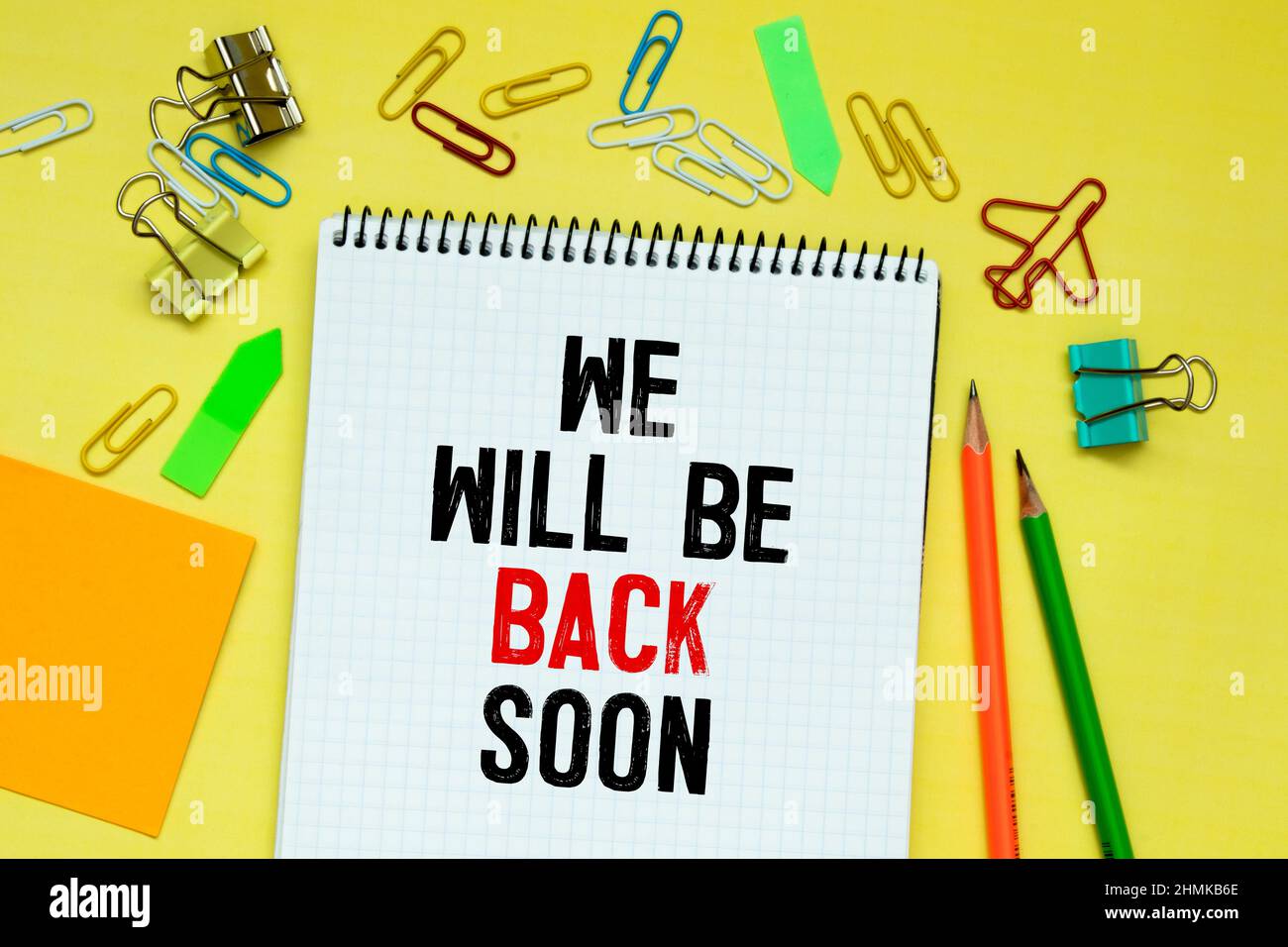 WE'LL BE BACK SOON text on paper with calculator,magnifier ,pen on ...