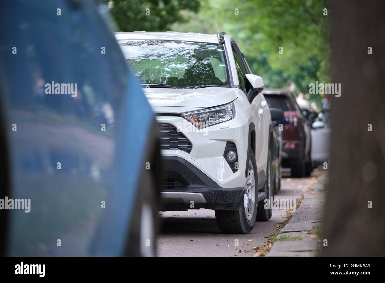 Cars parked in line on city street side. Urban traffic concept Stock ...