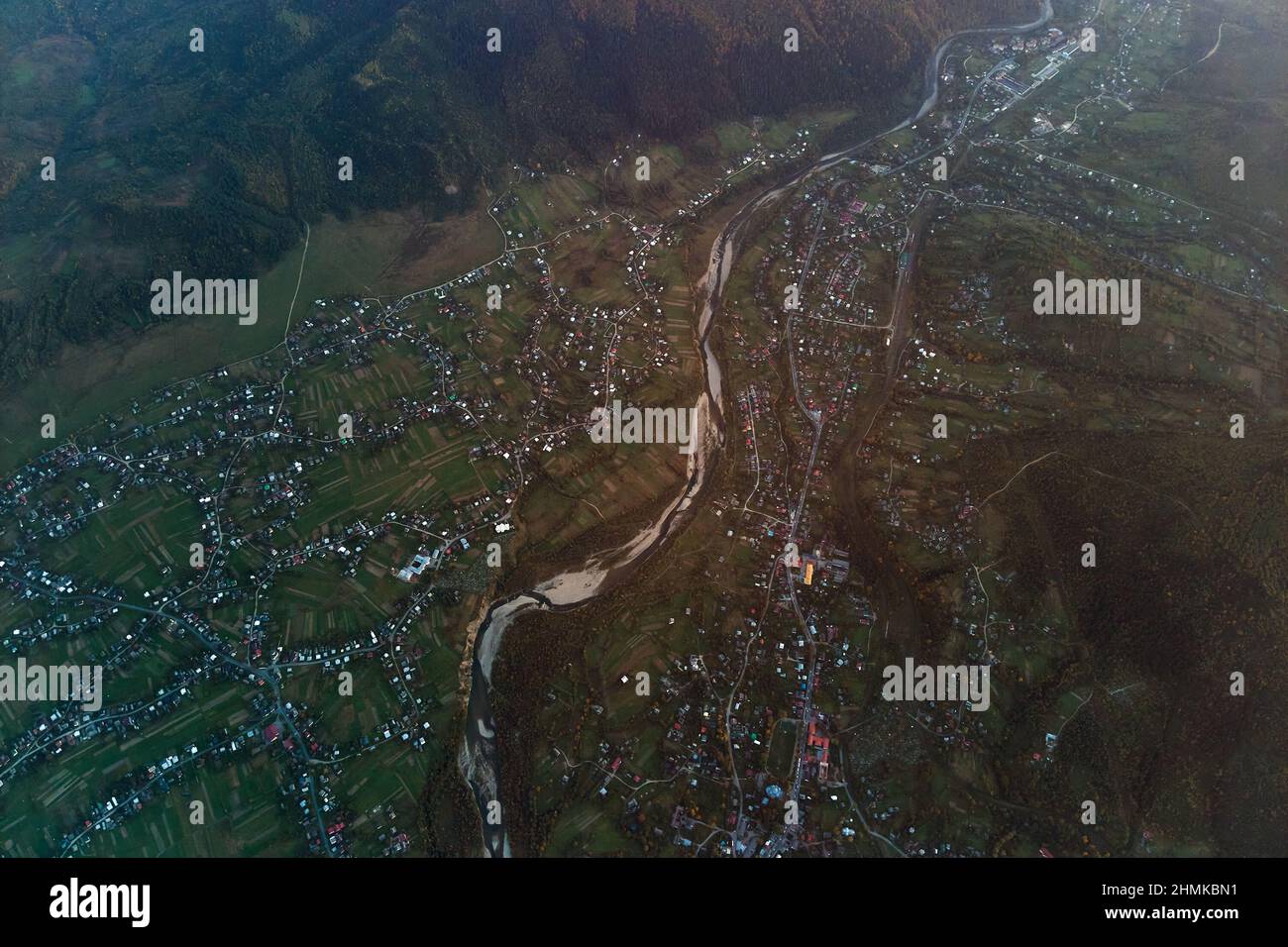 Aerial view from high altitude of distant scattered houses in rural ...