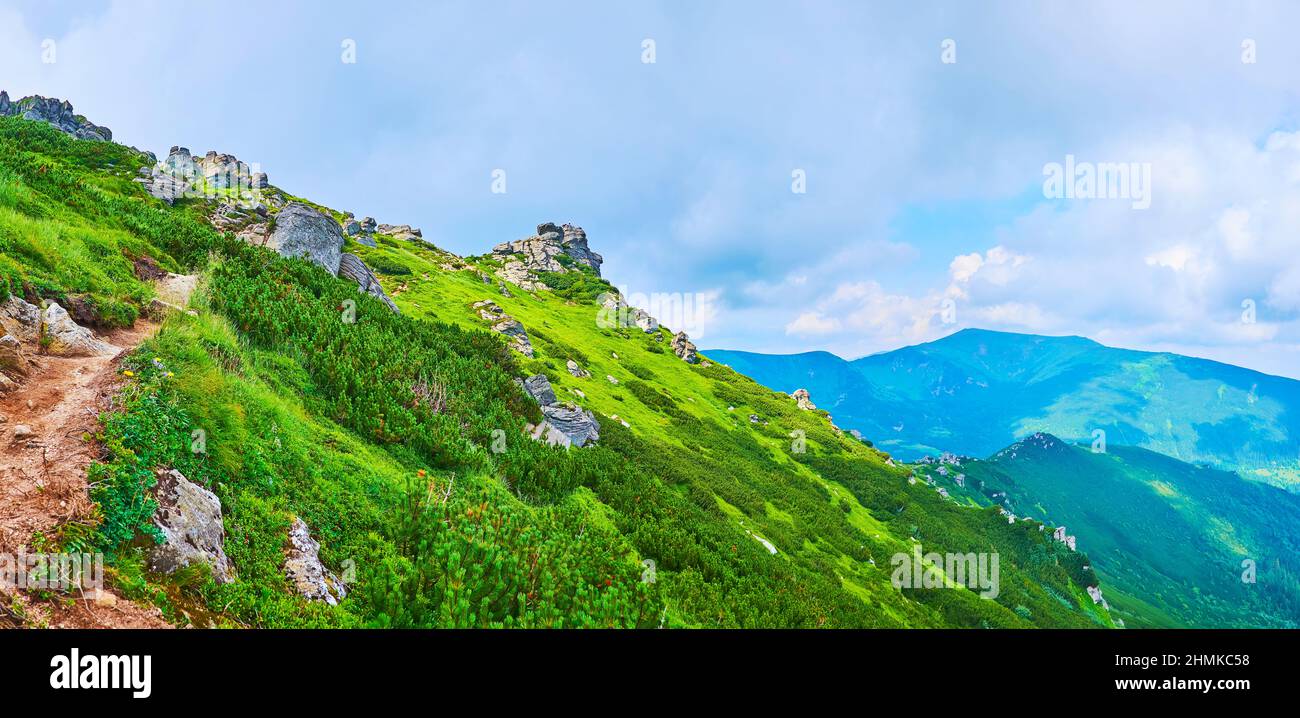 Panoramic view of the green slope of the Mount Eared Stone with the ...