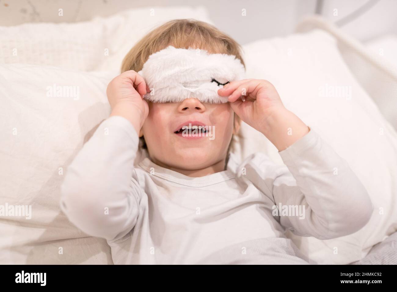 Cute little boy wearing mask sleeping in bed Stock Photo - Alamy