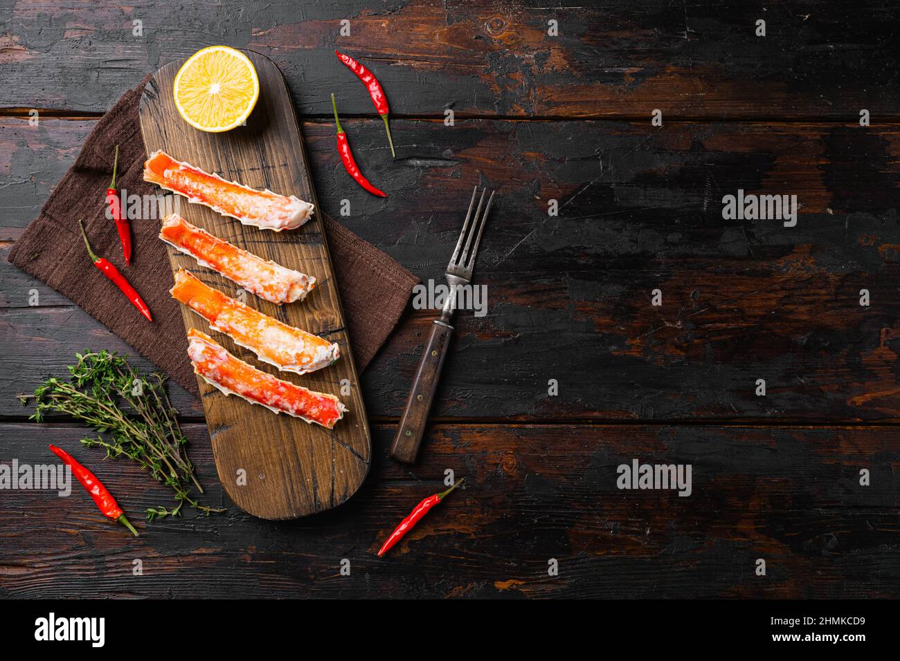 Delicious snow crab leg clusters set, on old dark wooden table ...
