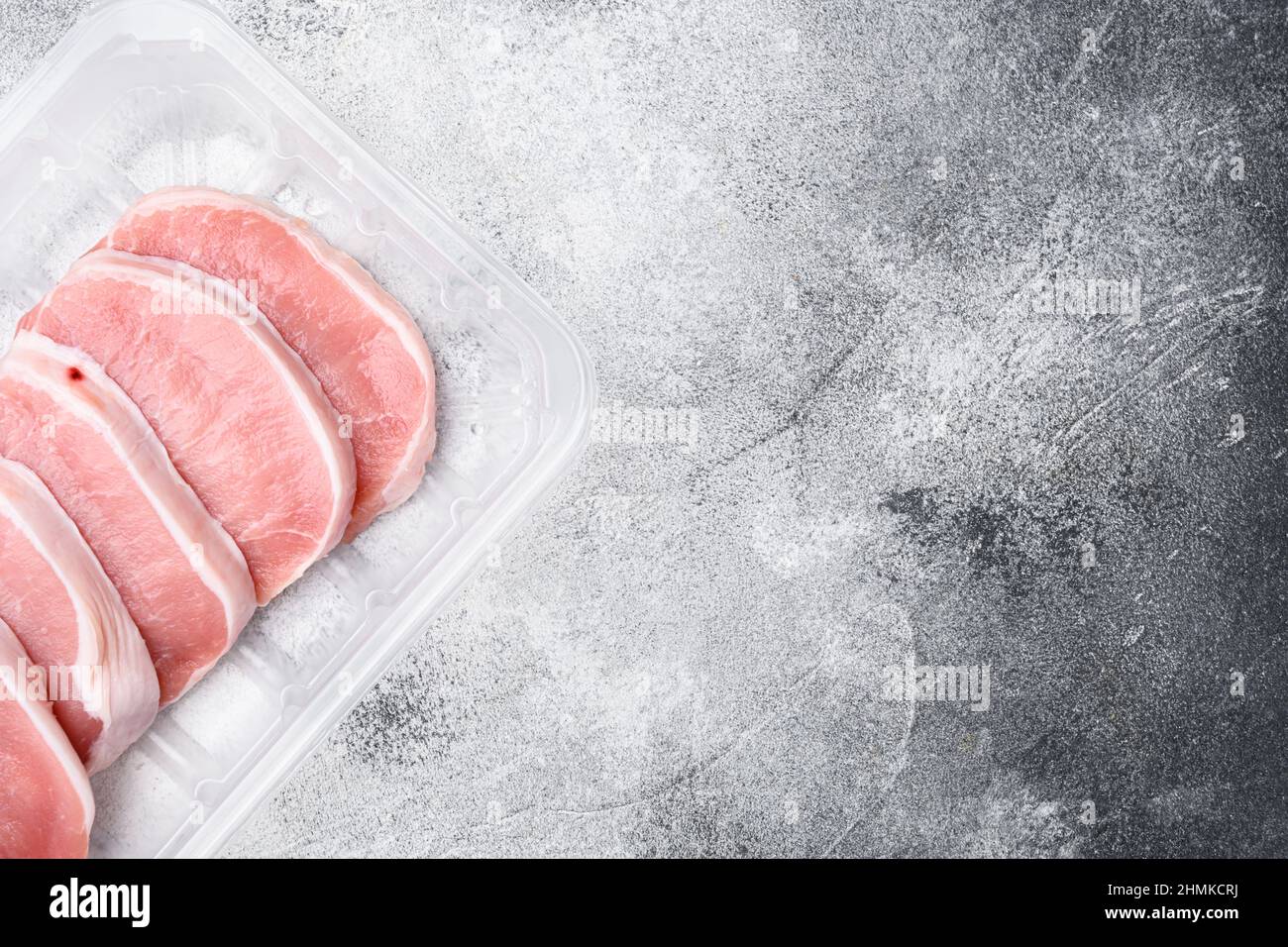 Pork chop sliced fresh meat set, in plastic pack container, on gray ...