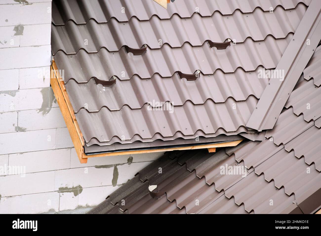 Closeup snow guard for safety in winter on house roof top covered with ...