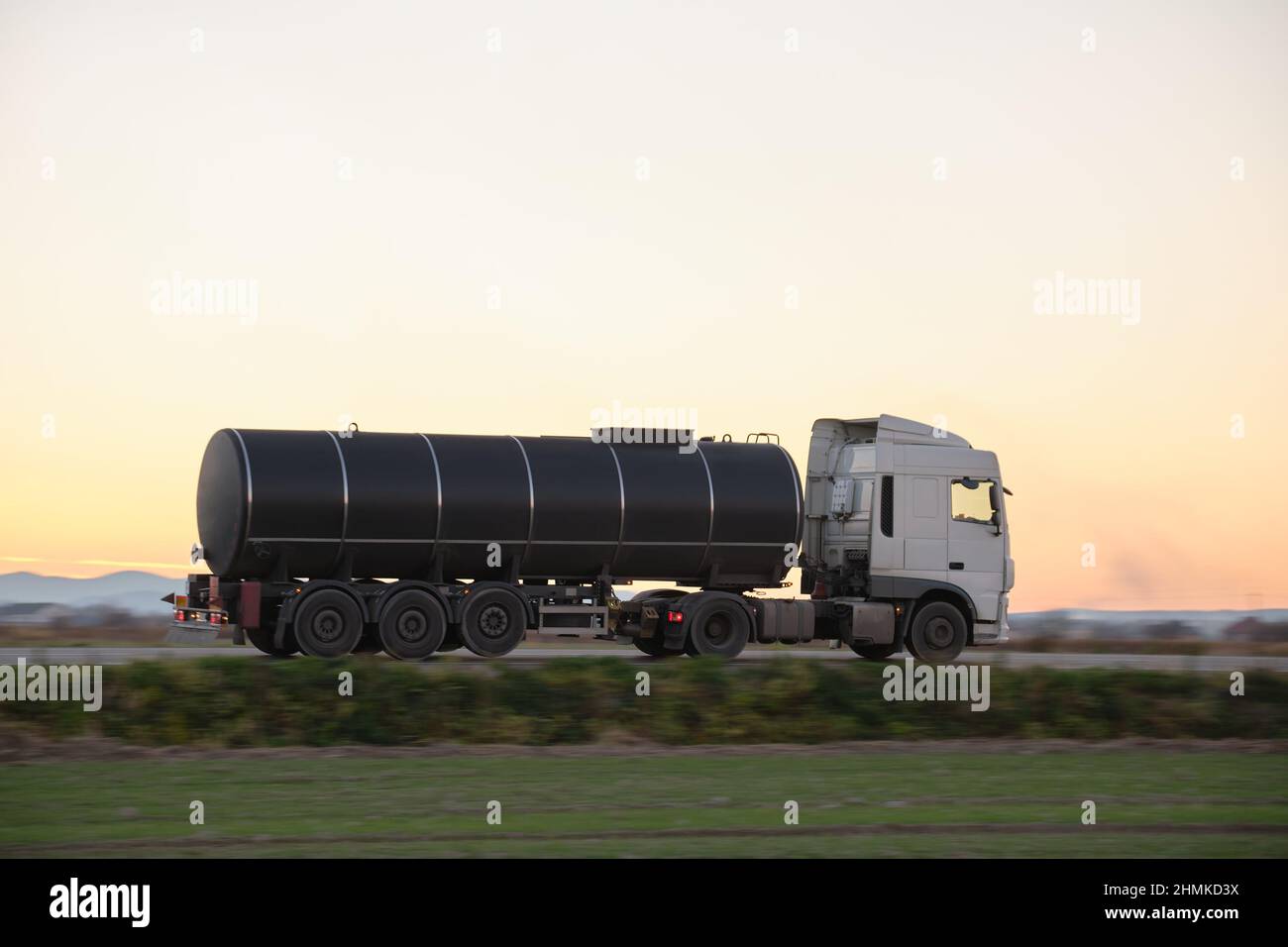Petrol cargo truck driving on highway hauling oil products. Delivery ...