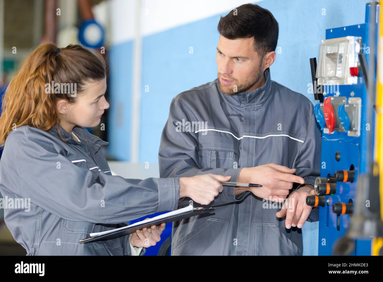 apprentice mechanic asking questions to her superior Stock Photo - Alamy