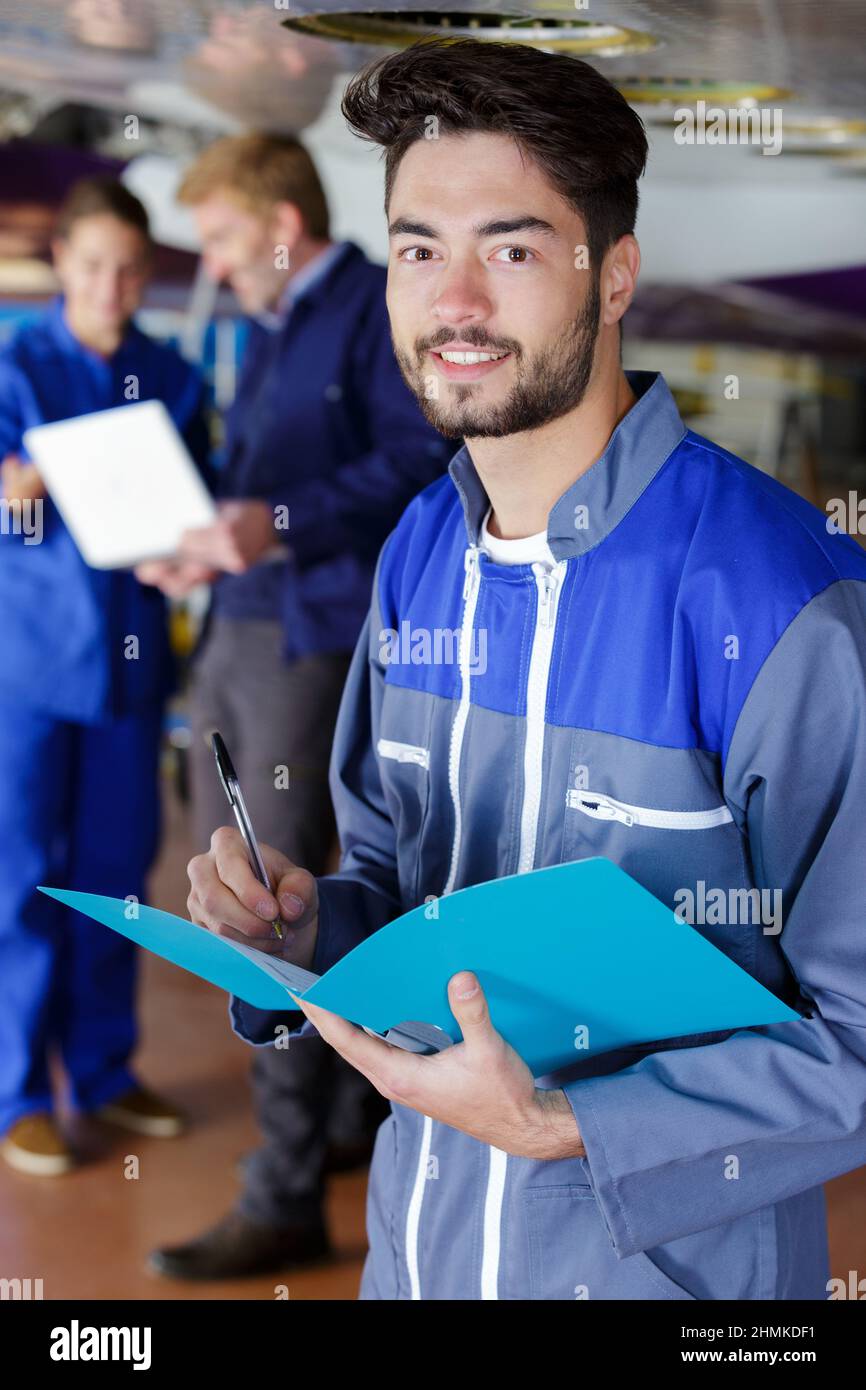 automotive industrial apprentice posing holding clipboard Stock Photo ...