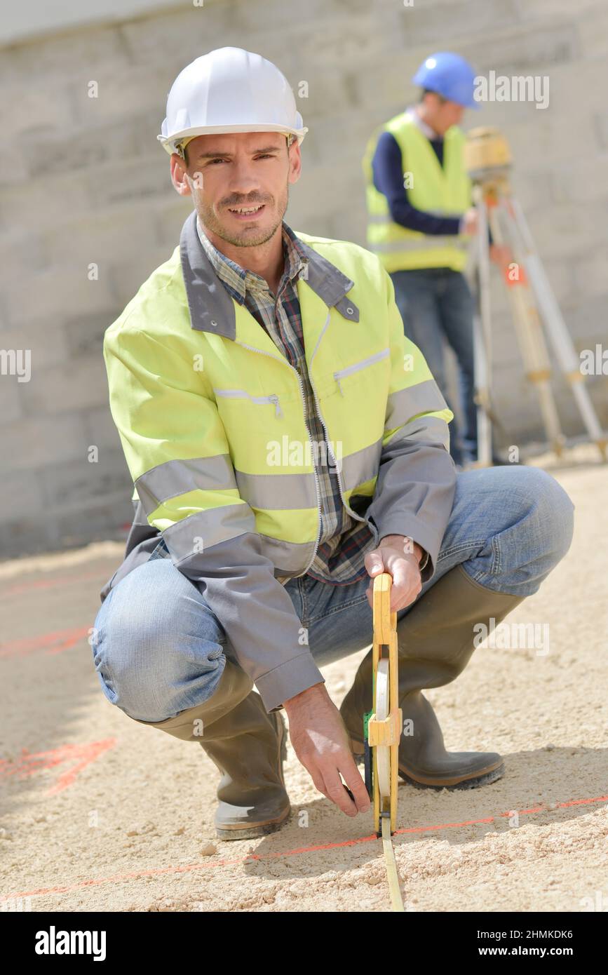 a surveyor using tape measure Stock Photo - Alamy