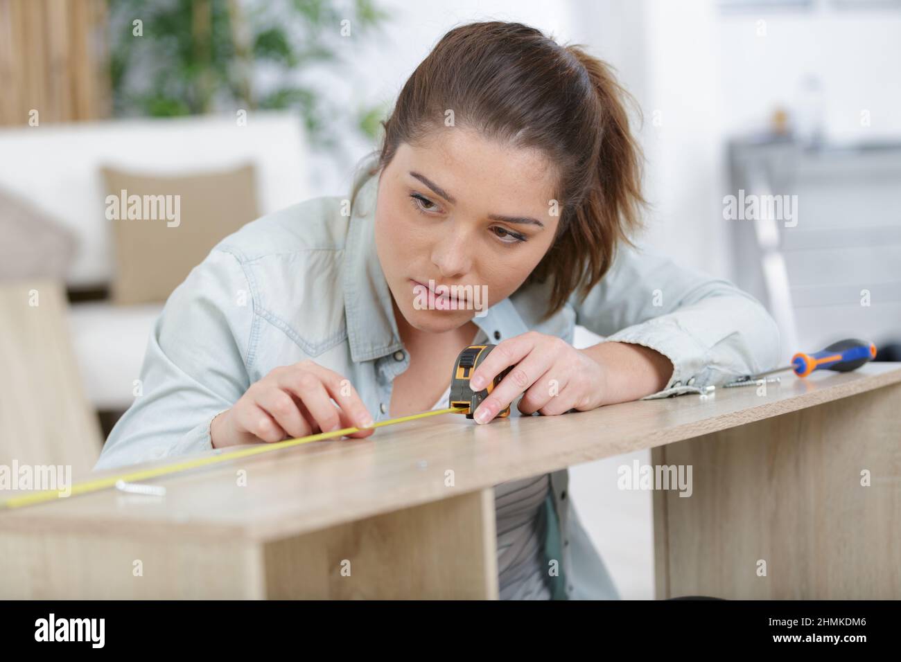 a female student measuring wood Stock Photo - Alamy