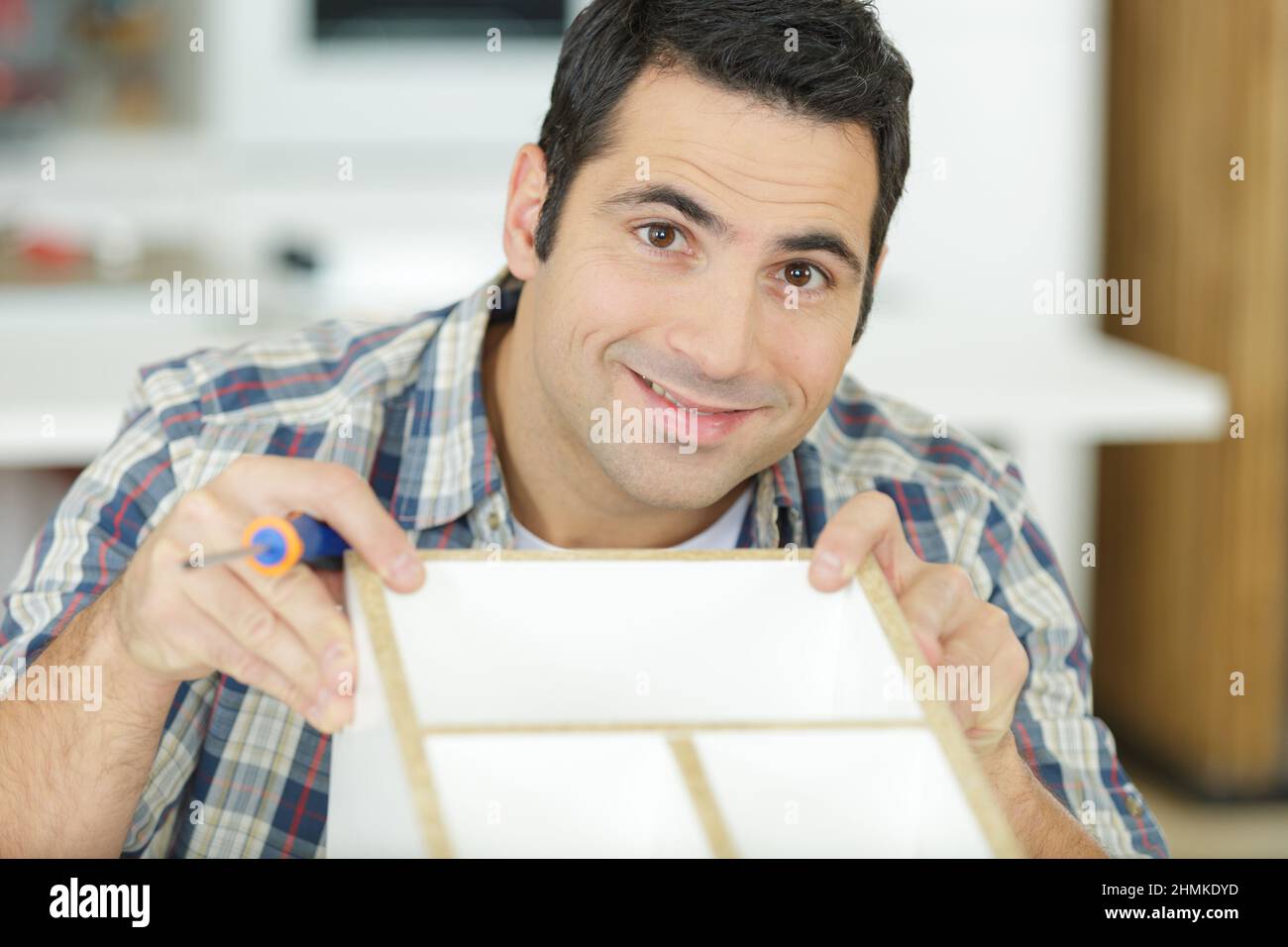 man repairing furniture at home Stock Photo - Alamy