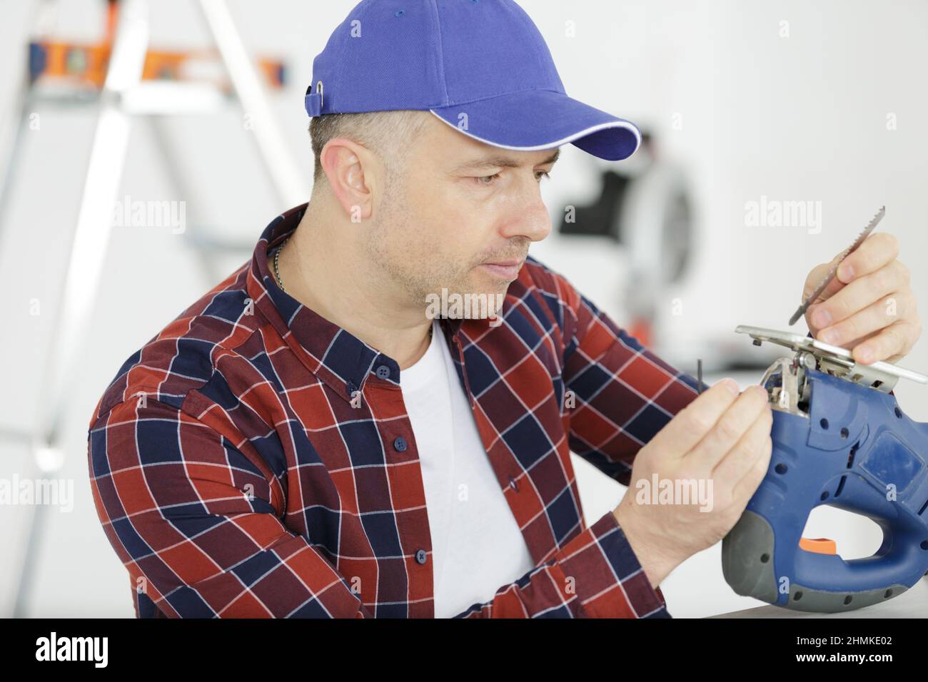 young worker using sanding machine Stock Photo - Alamy