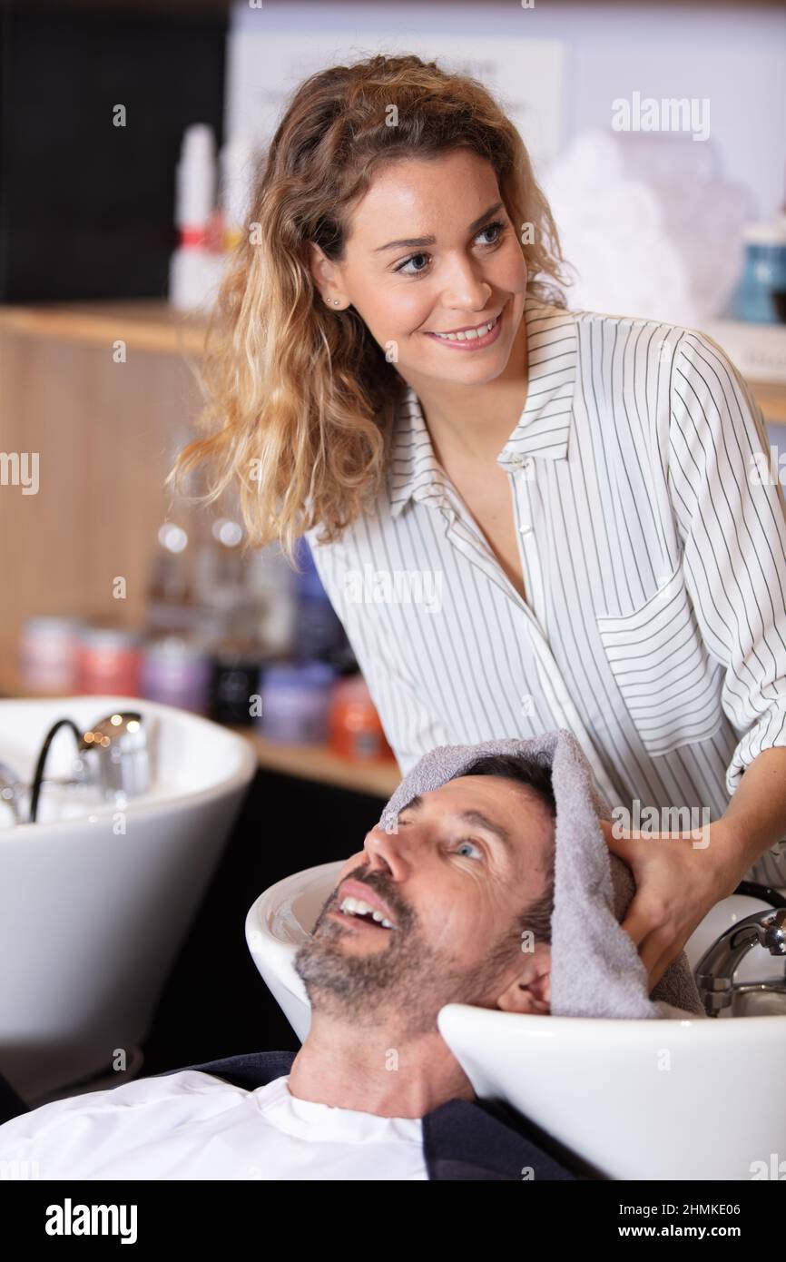 professional hairdresser drying mans hair after washing in sink Stock ...
