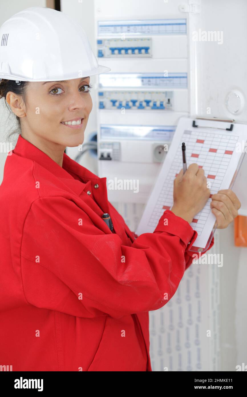 female electrician controlling saving meter Stock Photo - Alamy