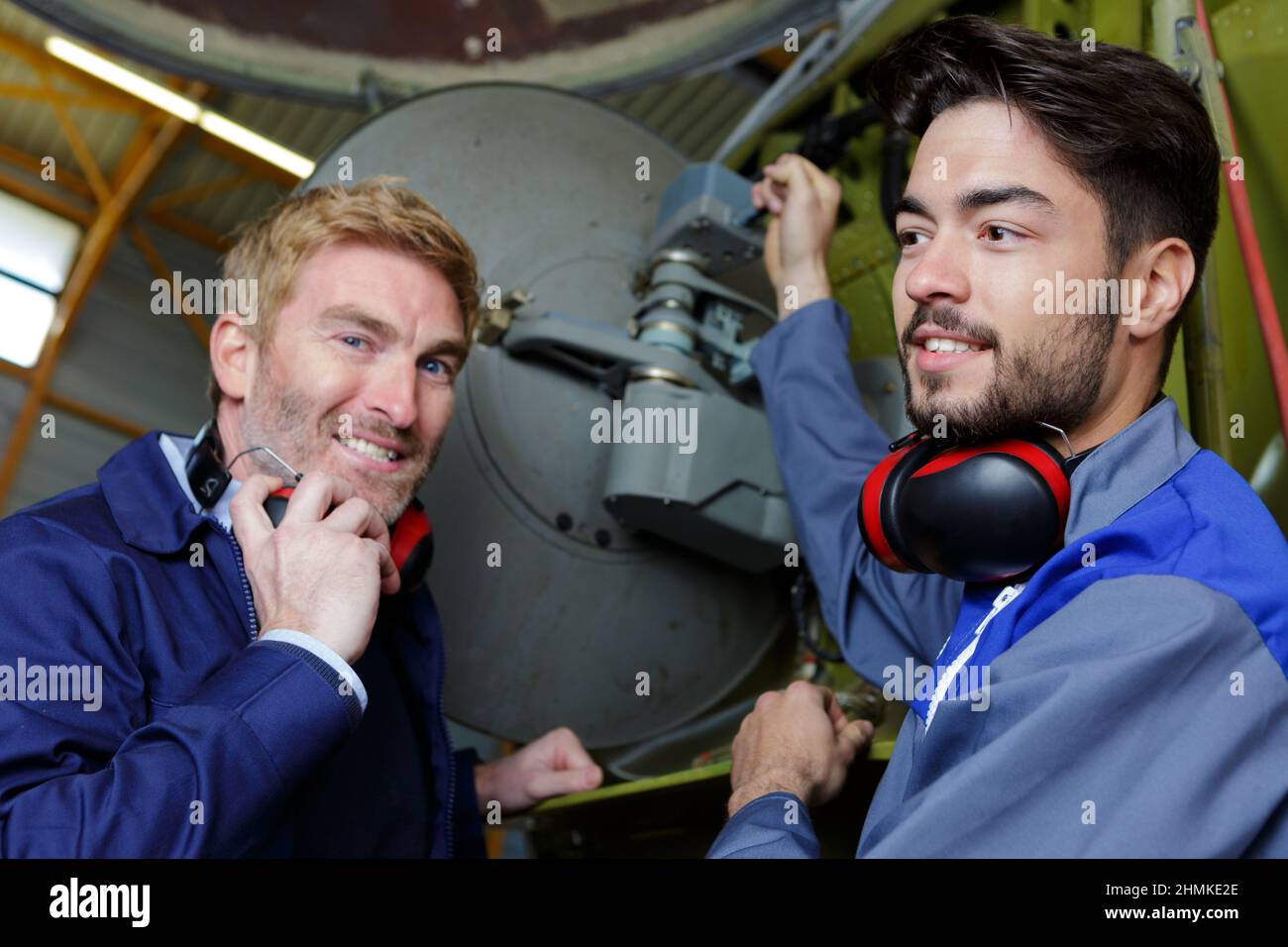 aviation mechanic with his apprentice Stock Photo - Alamy
